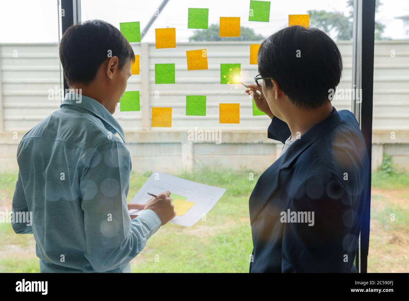 UX or UI designers designing on their smartphone application layout ...