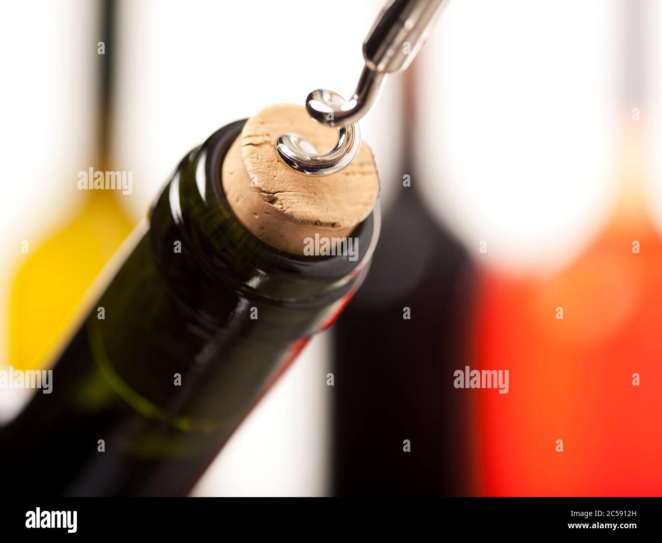 closeup of corkscrew pulling the cork from a red wine bottle Stock ...