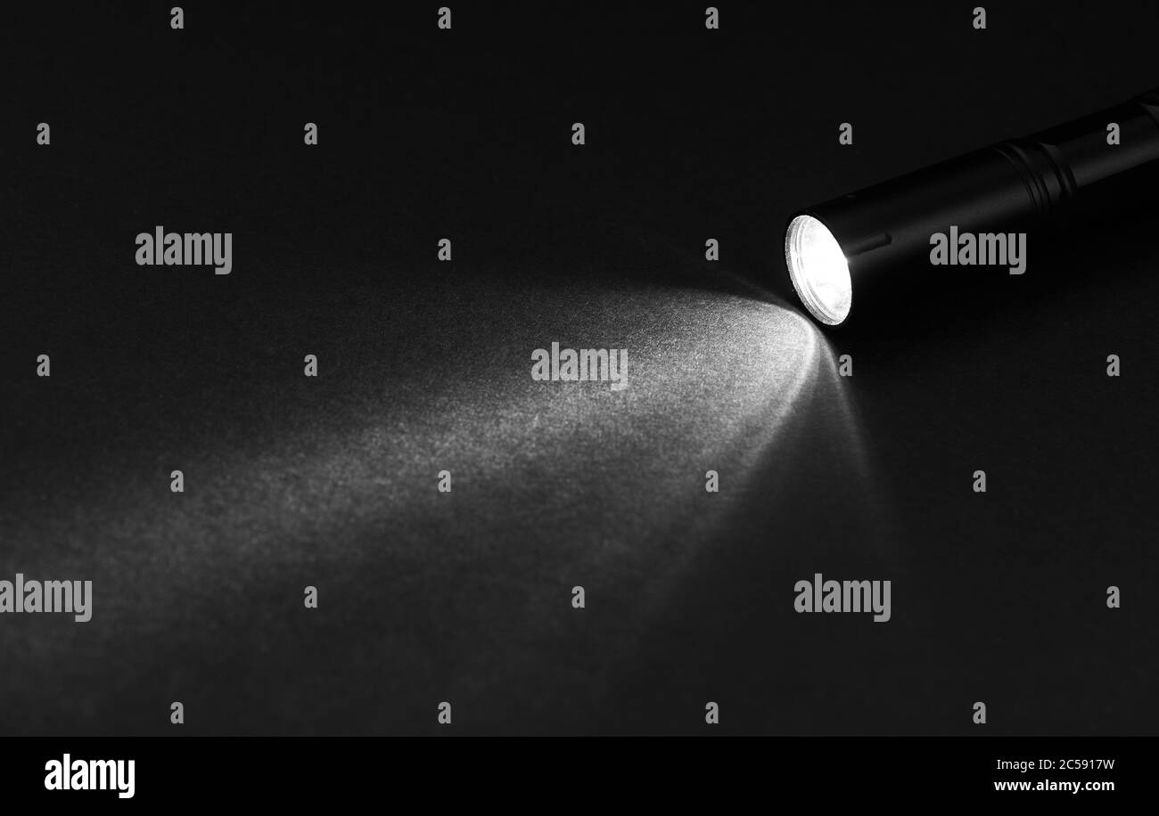 Flashlight and beam of light on a dark background Stock Photo - Alamy