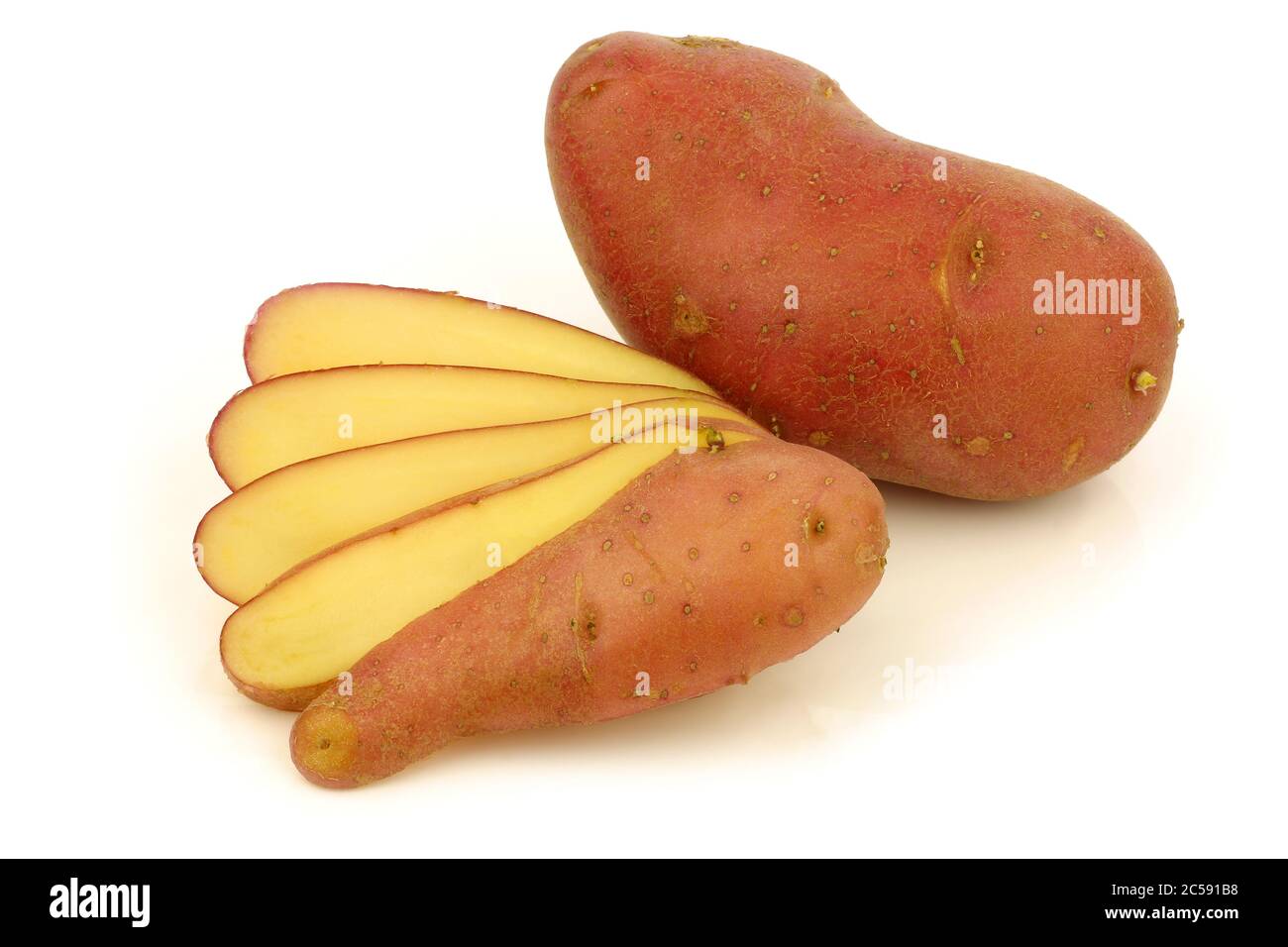 fresh roseval potato and a cut one on a white background Stock Photo ...