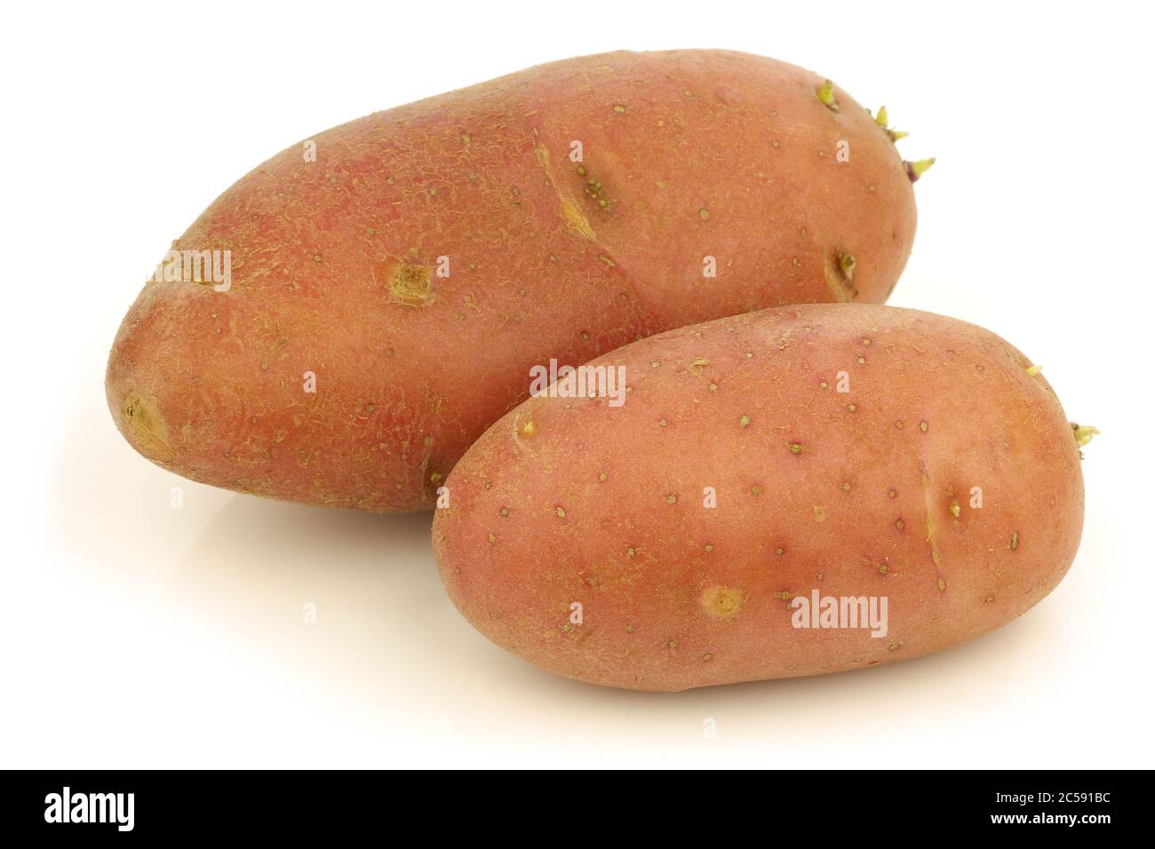 fresh roseval potatoes on a white background Stock Photo - Alamy