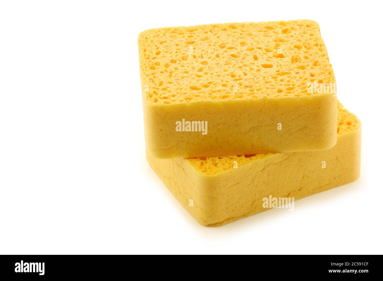 yellow household sponges on a white background Stock Photo - Alamy