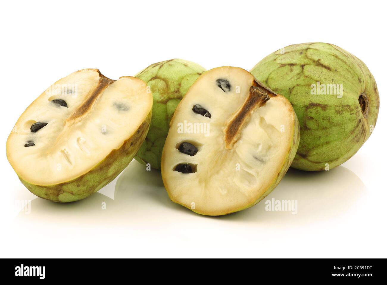 fresh cherimoya fruits (Annona cherimola) and a cut one on a white ...