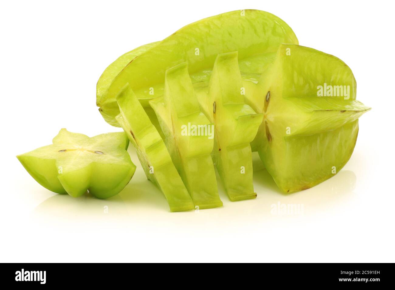 fresh green starfruit and a cut one a on a white background Stock Photo ...