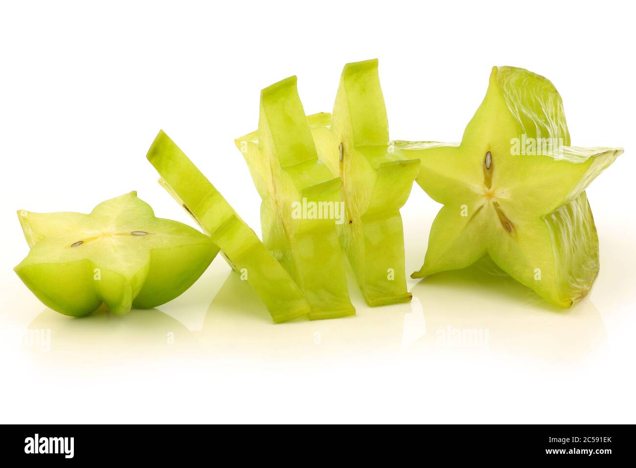 fresh green pieces of starfruit on a white background Stock Photo - Alamy