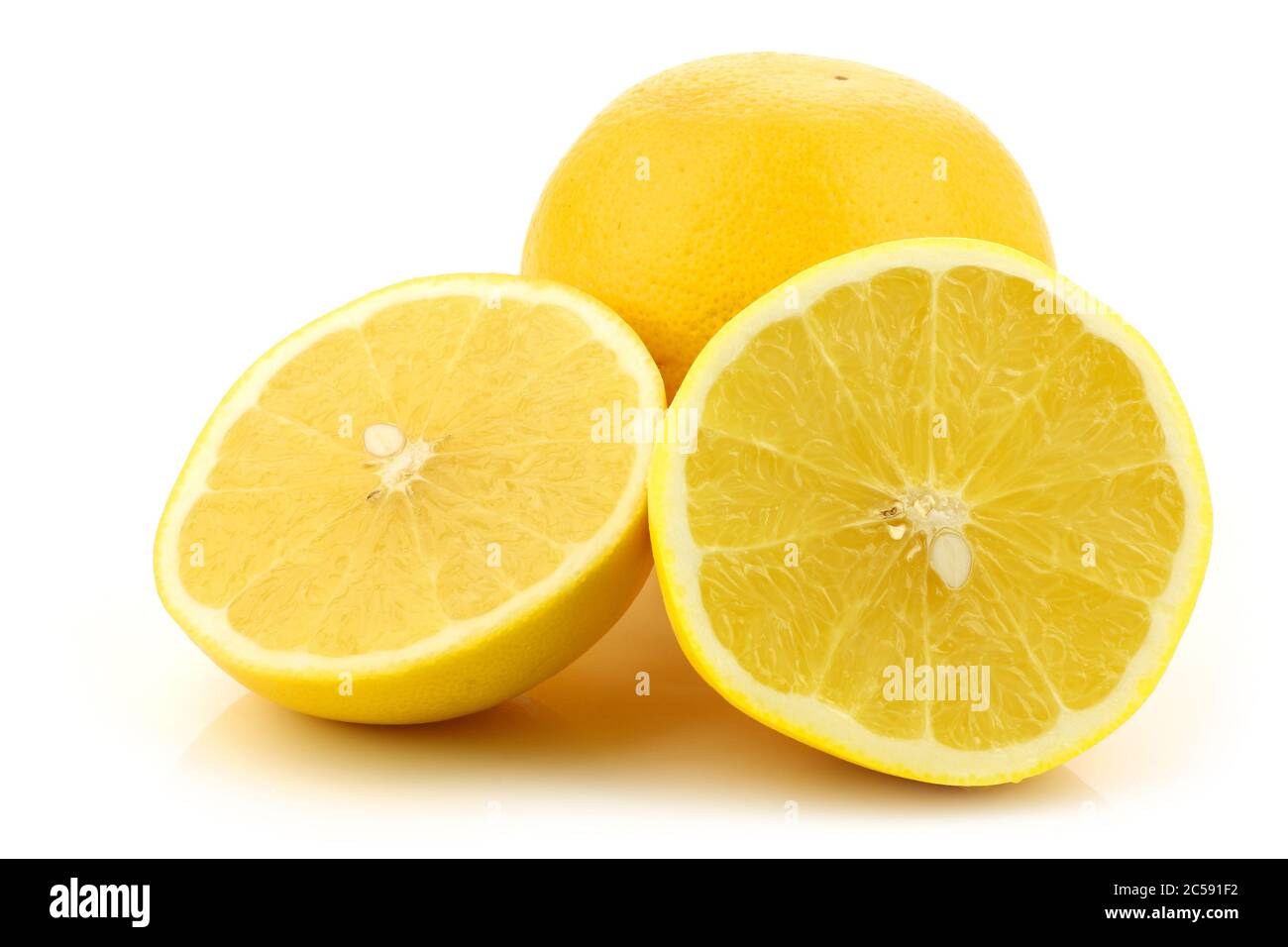 yellow grapefruit and a cut one on a white background Stock Photo - Alamy
