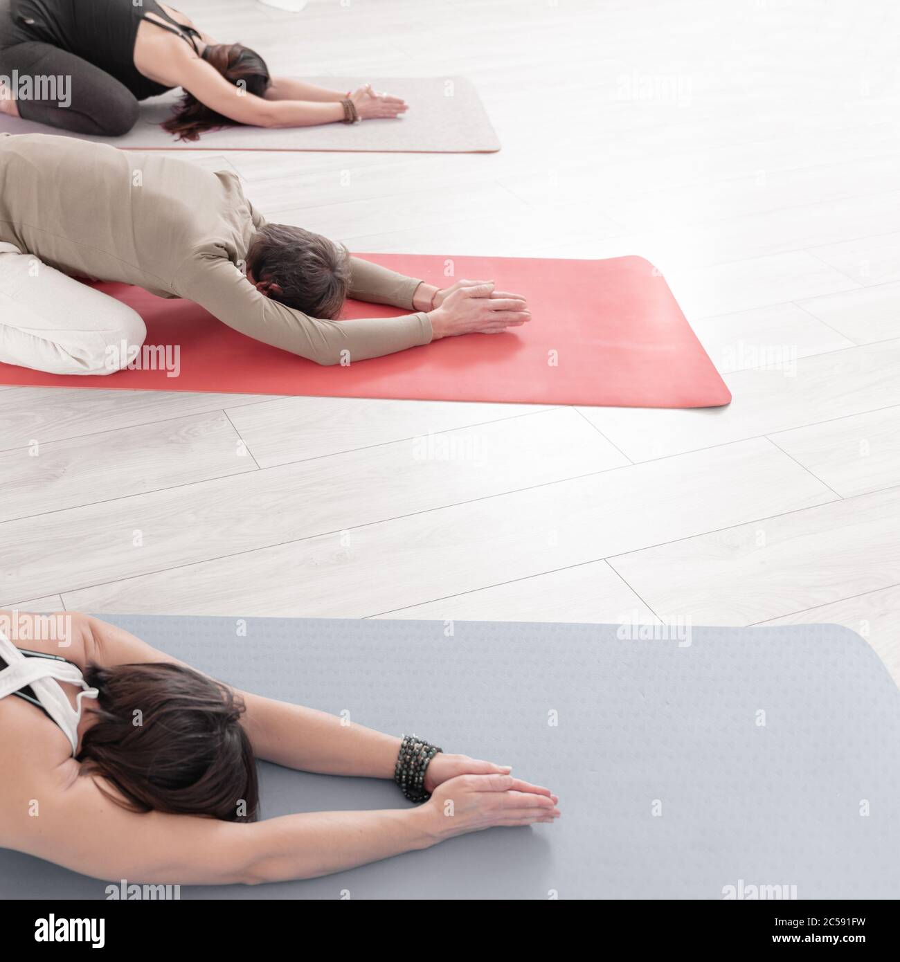Group of people practicing Yoga. Shashankasana position. Rabbit Pose ...
