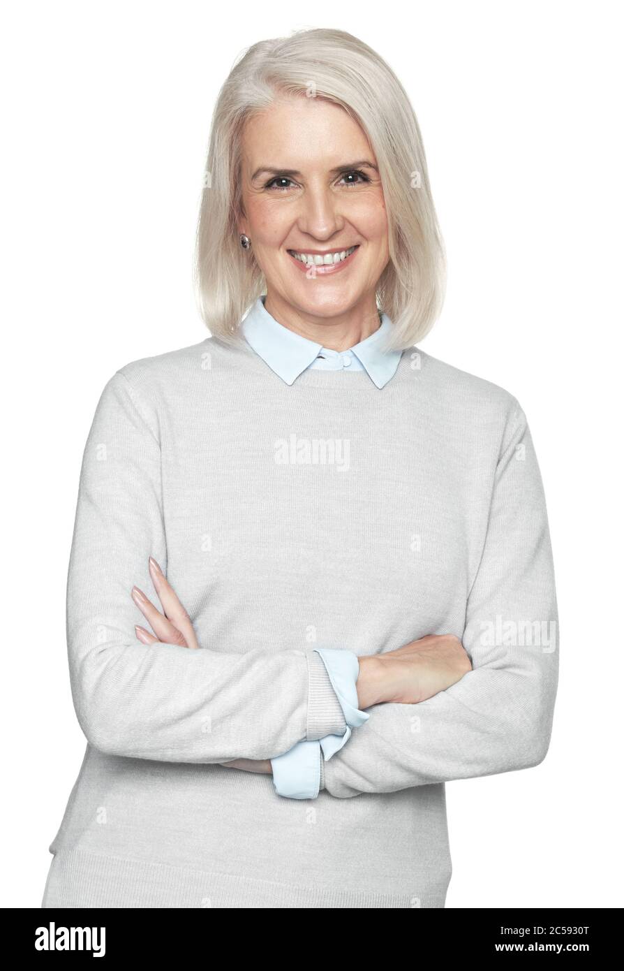 portrait of a beautiful older woman smiling and standing with arms crossed. Isolated on white ...