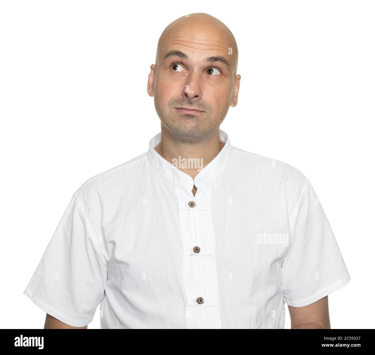 Pensive bald man smiling looking up. Isolated over a white background ...