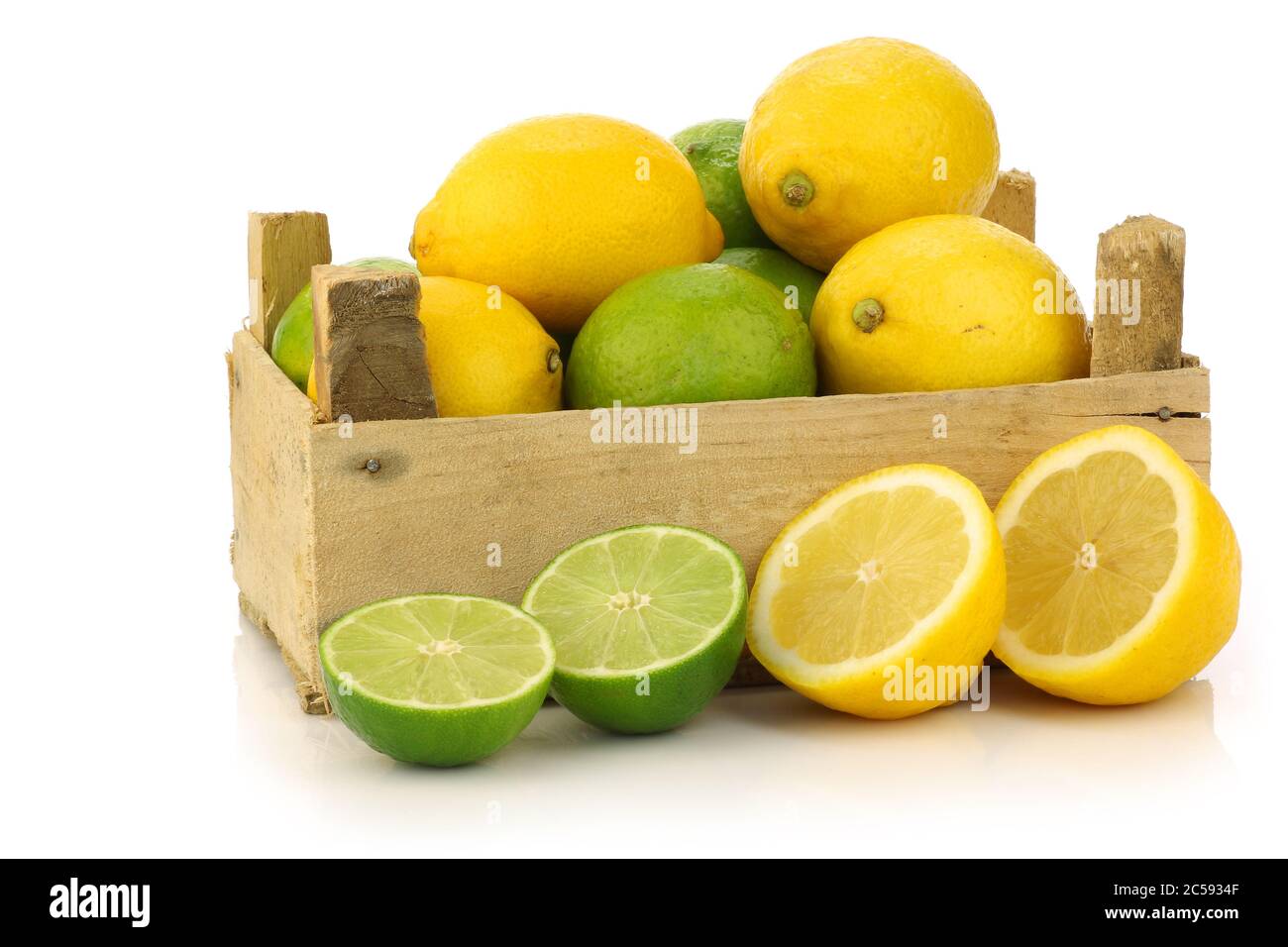 fresh lemons and lime fruits in a wooden box on a white background ...