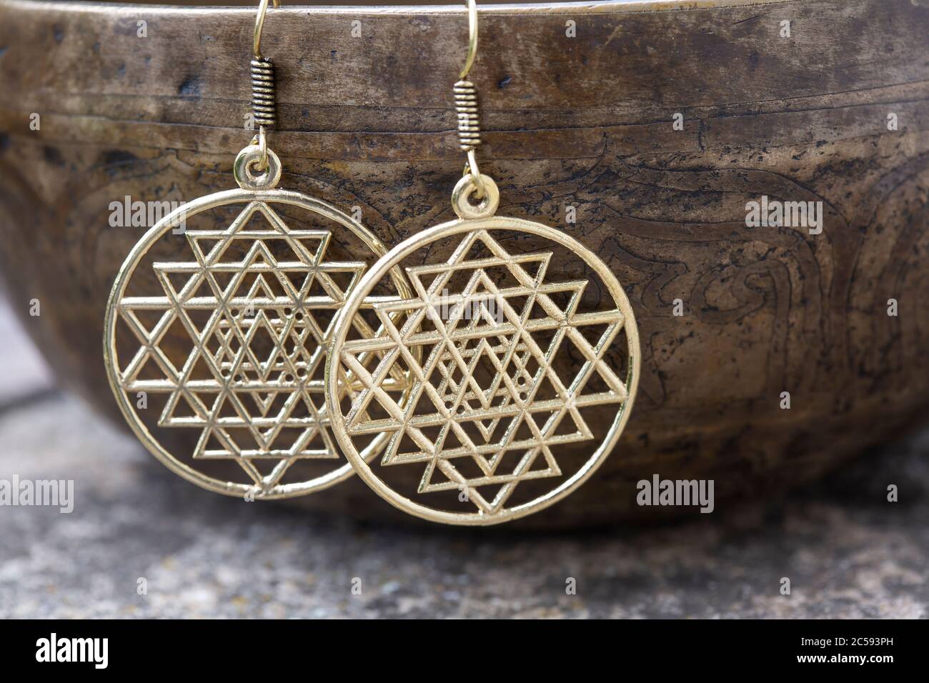 Brass metal boho style Indian sacred geometry earrings Stock Photo - Alamy