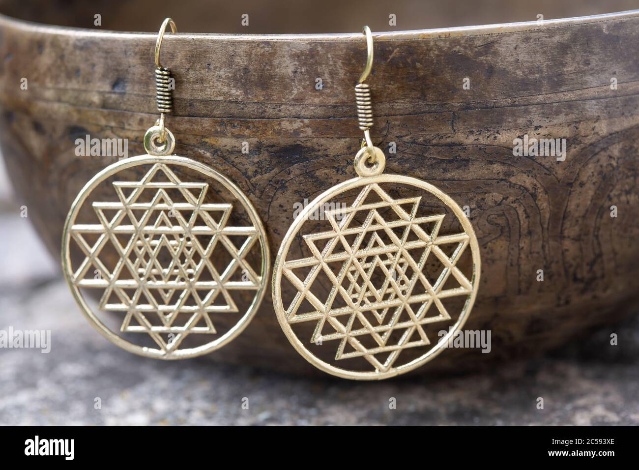 Brass metal boho style Indian sacred geometry earrings Stock Photo - Alamy