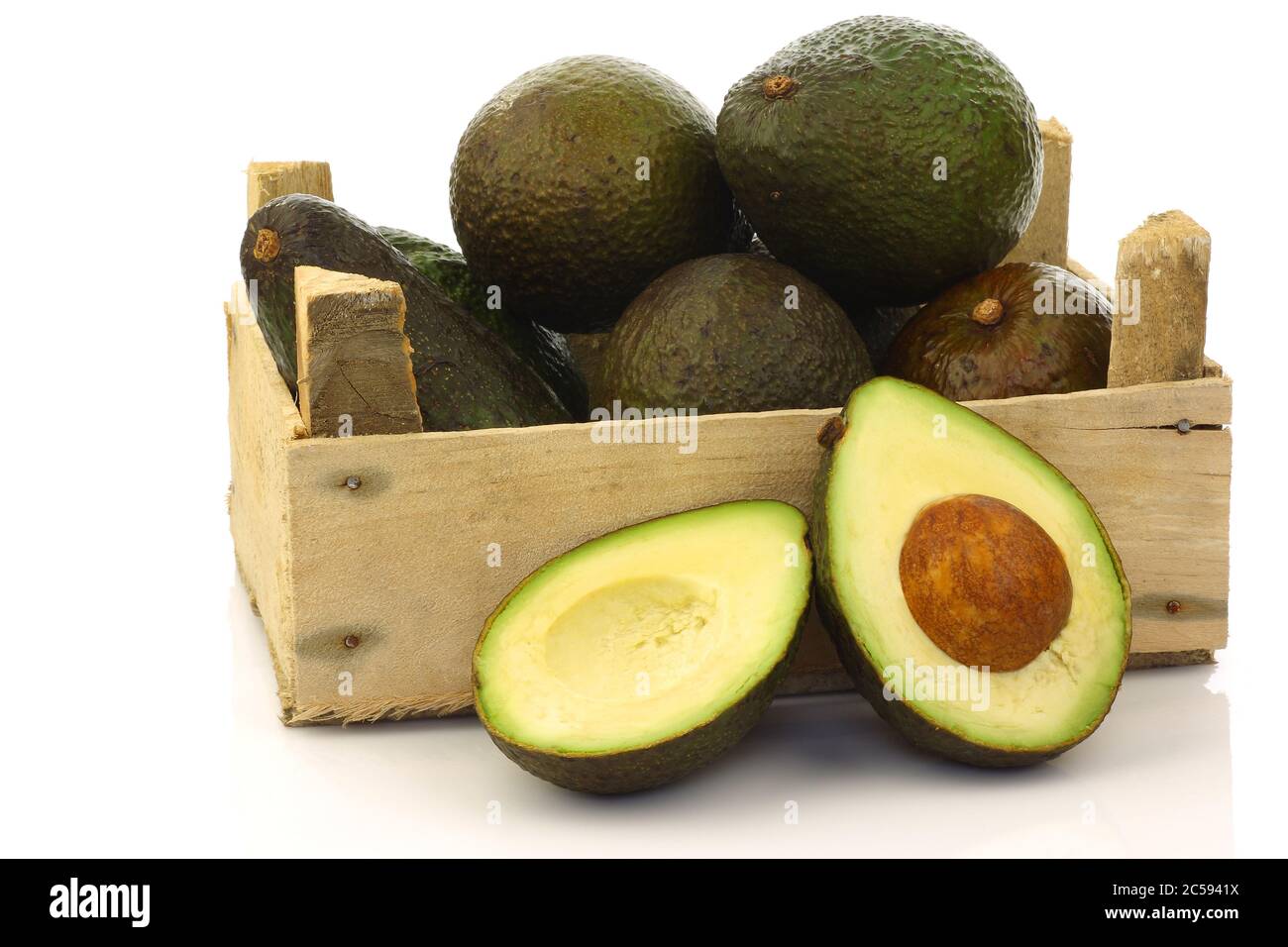 fresh and ripe avocado's in a wooden crate on a white background Stock ...