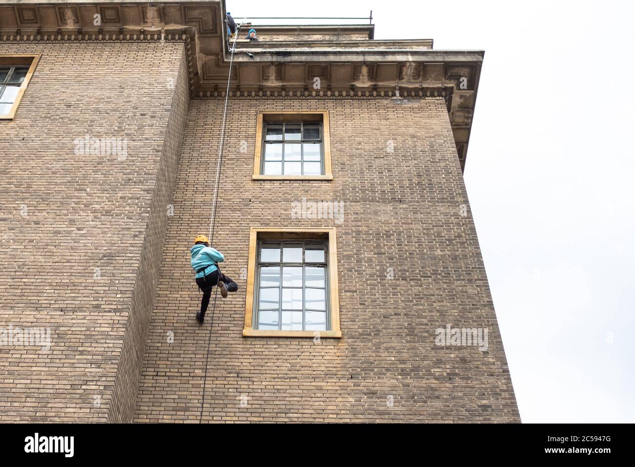 Young abseiling woman seen defending down a tall building in Cambridge ...