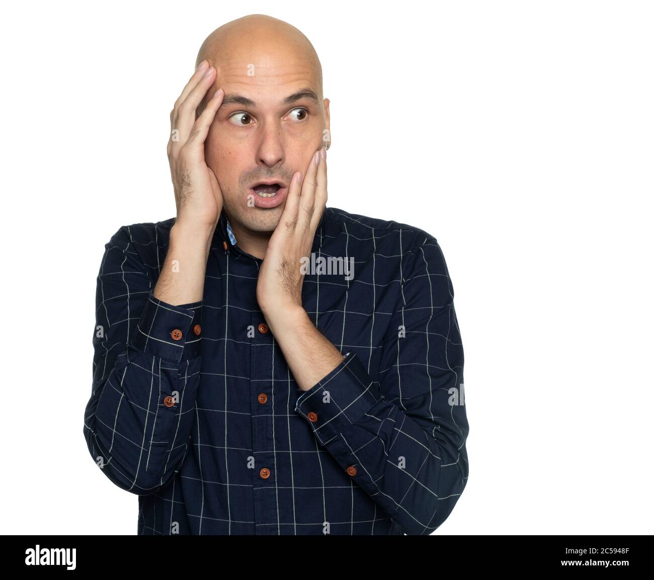 afraid man looking aside while holding his head in hands. Isolated on ...