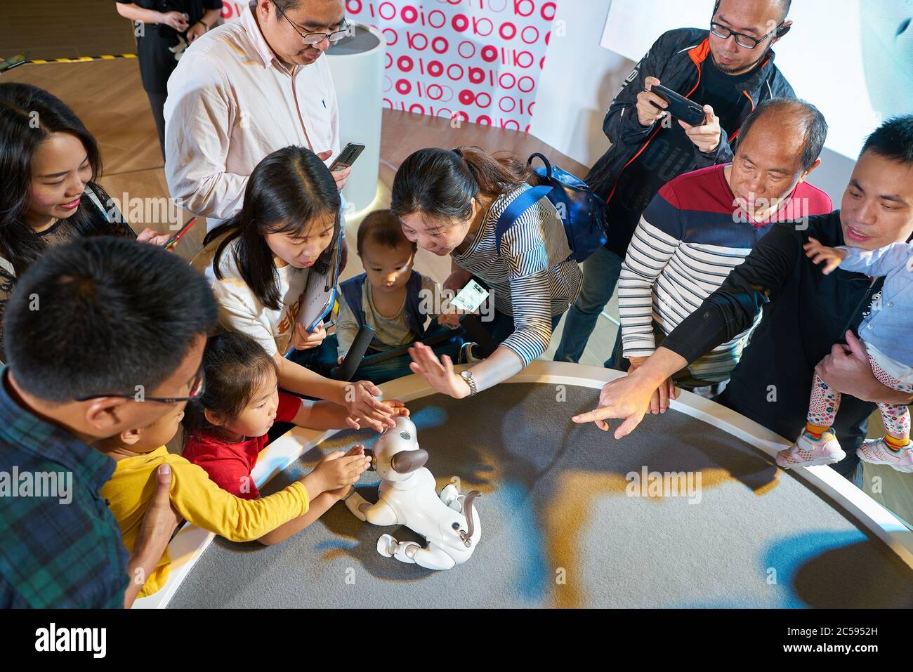 SHENZHEN, CHINA - CIRCA APRIL, 2019: people play with Sony's Aibo robot dog at Sony Expo 2019 at ...