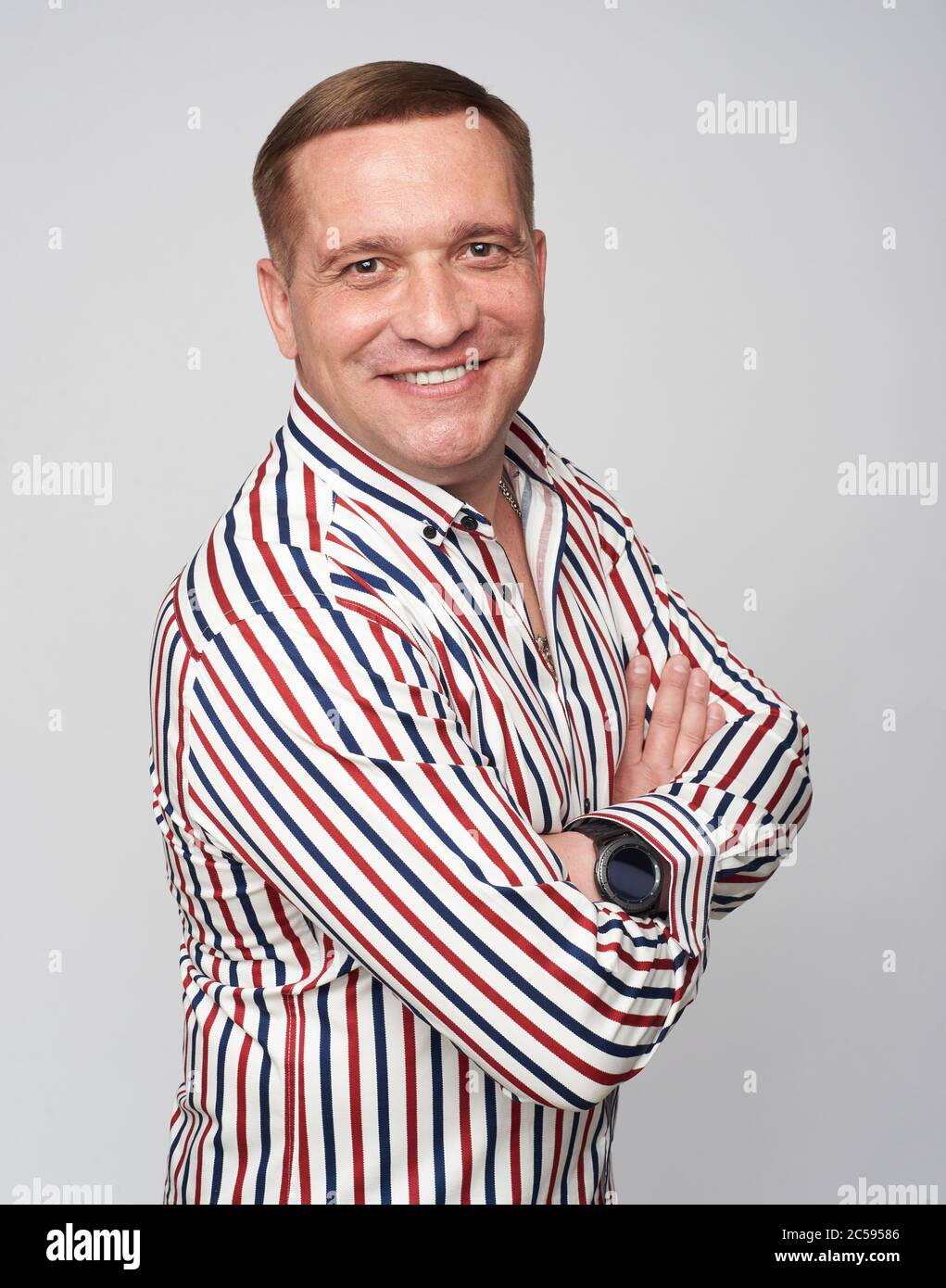 Fashionable 40 years old man is smiling. Isolated on grey studio ...