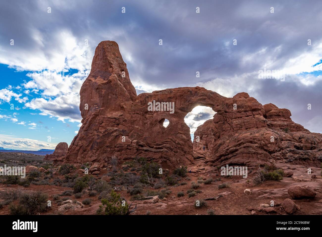 Beautiful Turret Arch rock formation backlit by the sun and dramatic ...
