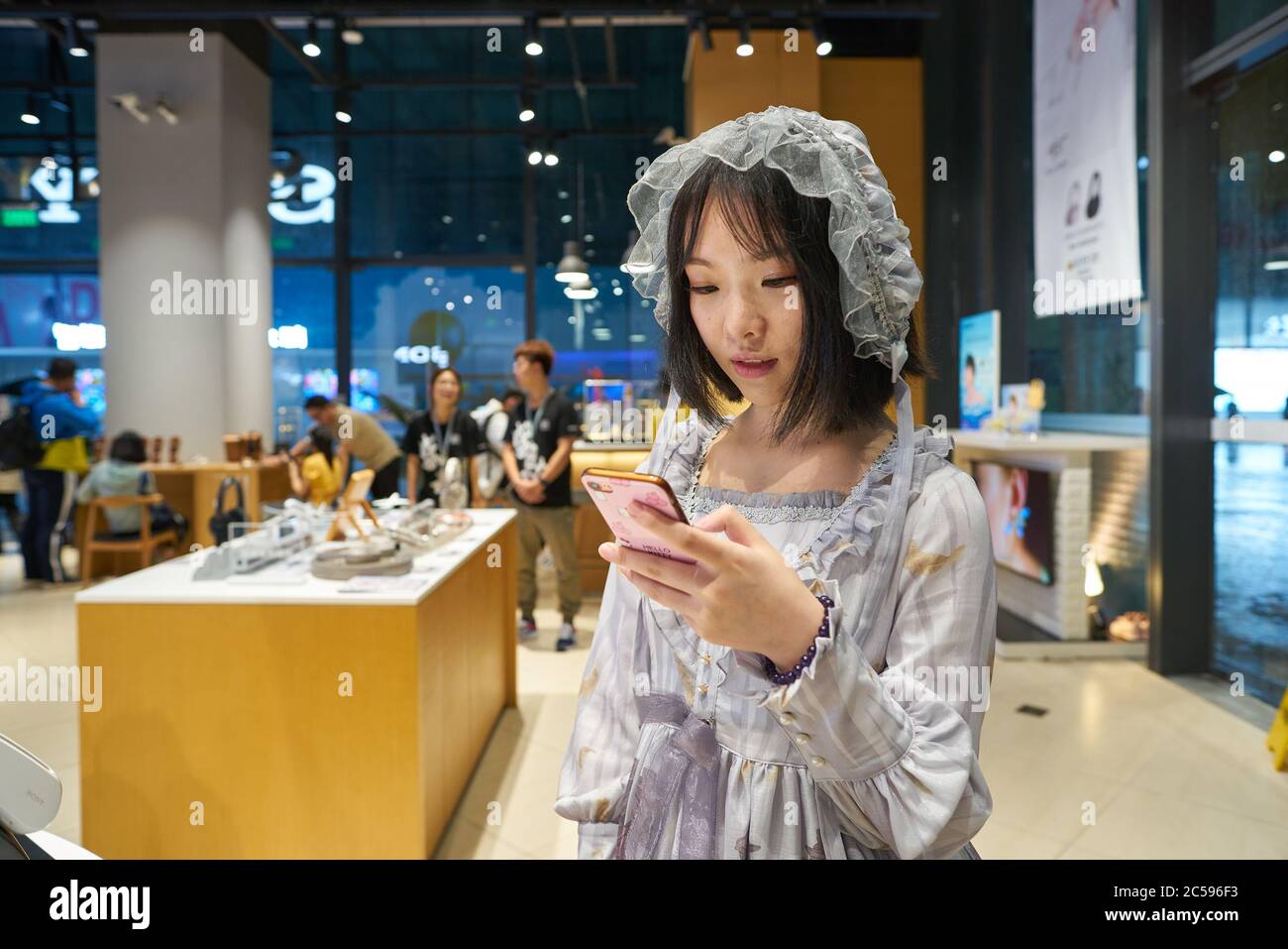 SHENZHEN, CHINA - CIRCA APRIL, 2019: Chinese woman with phone at Sony ...