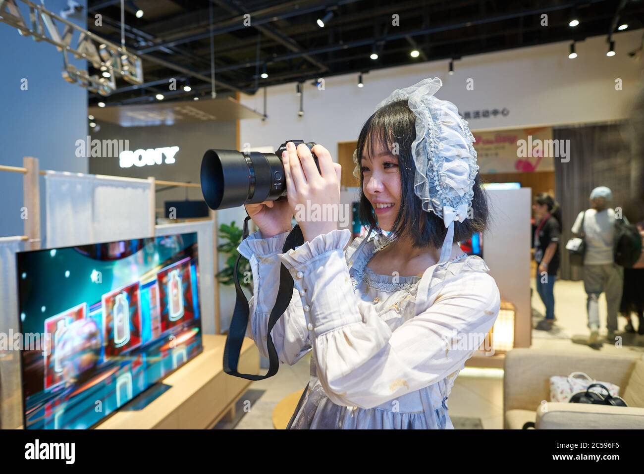 SHENZHEN, CHINA - CIRCA APRIL, 2019: Chinese woman with digital camera ...