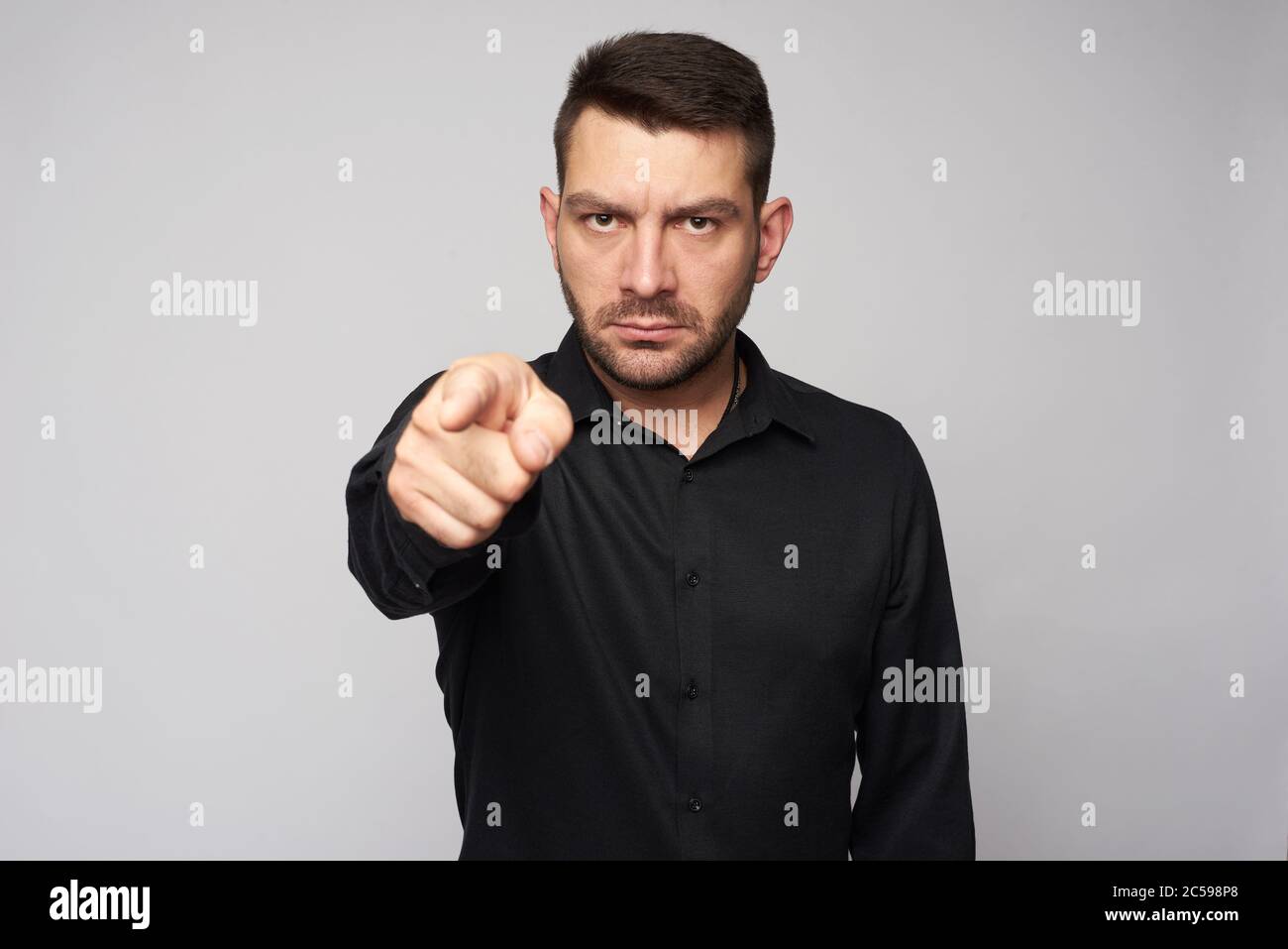 Bearded serious man pointing finger at you. Isolated on grey studio ...