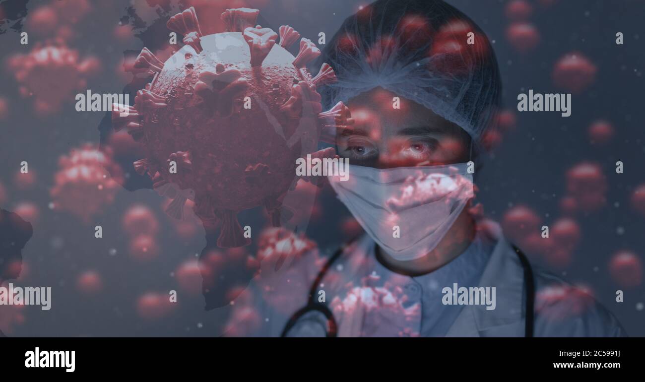 Covid-19 cells against doctor wearing face mask Stock Photo - Alamy