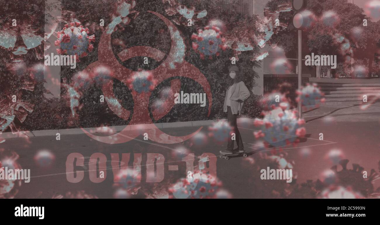 Hazard sign and Covid-19 text and cells against woman wearing face mask ...