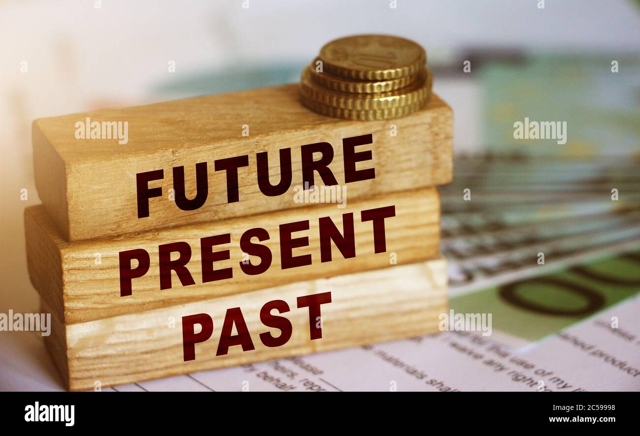Past Present Future words written on wood block. 100 Euro banknotes and ...
