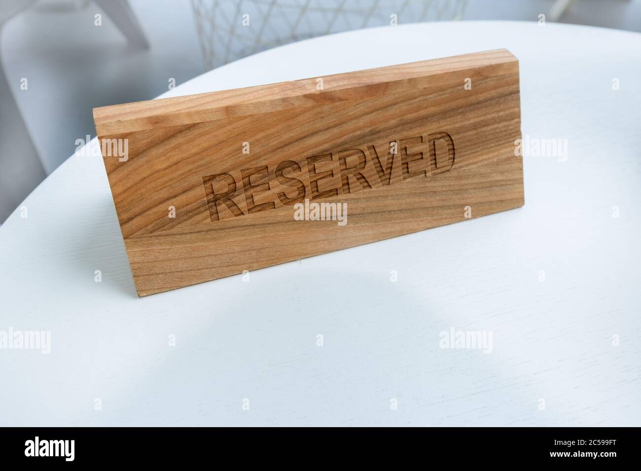 A tag of reservation placed on table. Reserved logo in a restaurant or ...