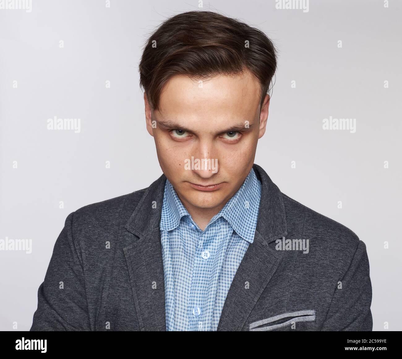 Face of an angry male isolated on a grey background Stock Photo - Alamy