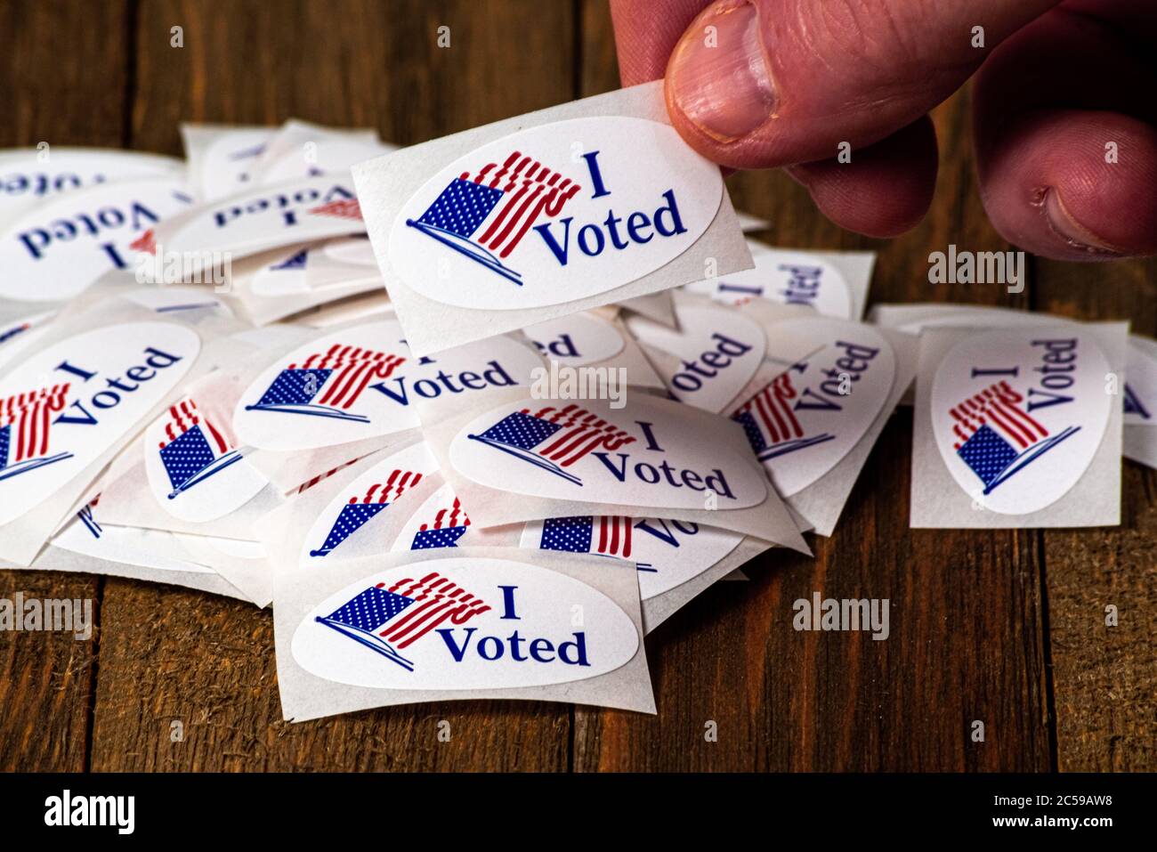 Denver, CO--June 30; hand reaching into pile of red white and blue oval ...