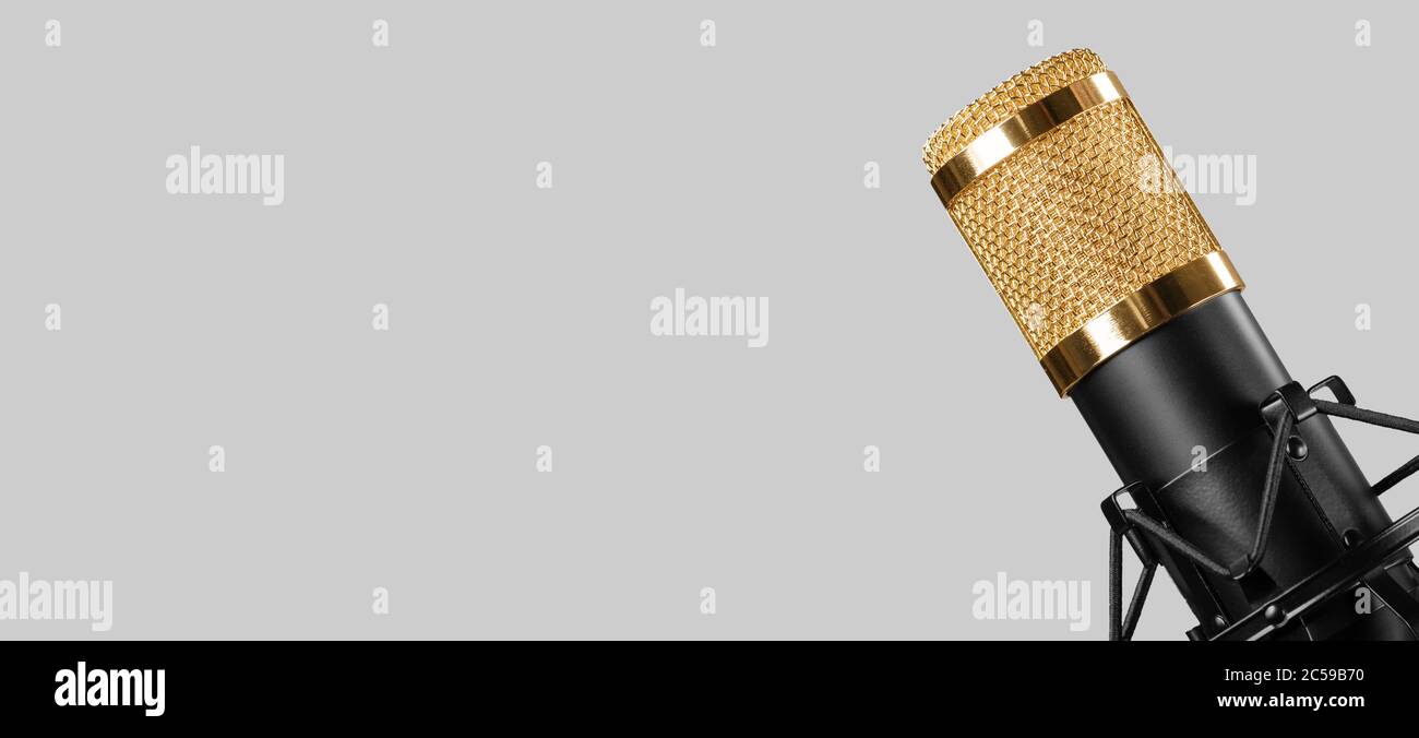 Golden microphone isolated on grey background Stock Photo - Alamy