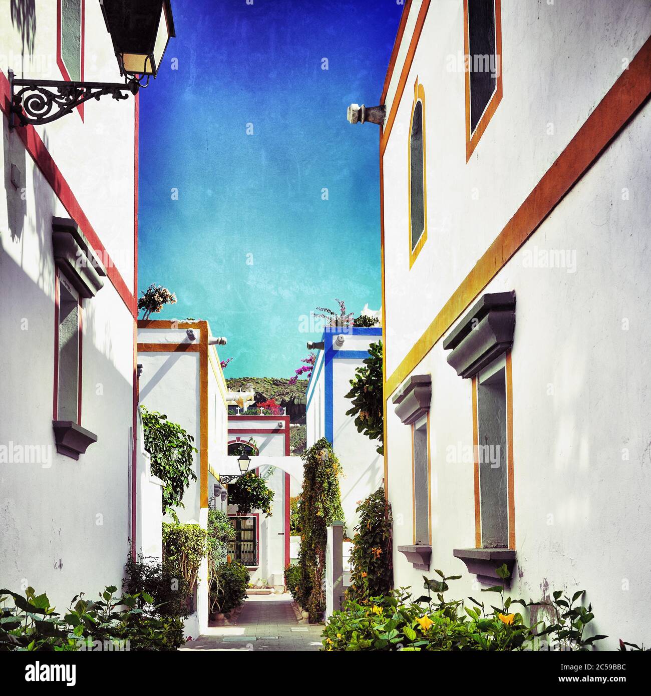 Street with white houses colonia shown in Puerto de Mogan, Spain ...
