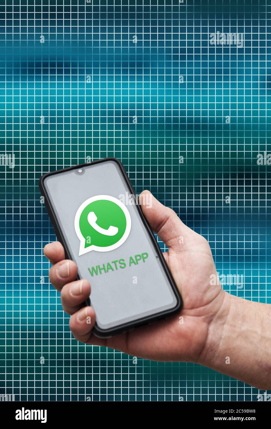 hand holding a smartphone with WhatsApp logo on the screen Stock Photo ...