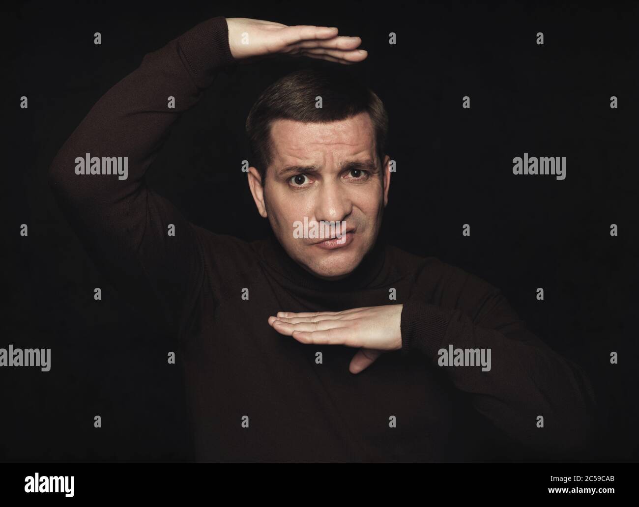 Human facial expressions. Confused guy isolated on black studio ...