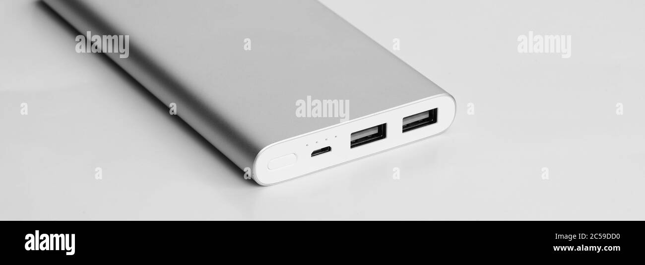 Modern power bank for charging mobile devices on grey background Stock ...