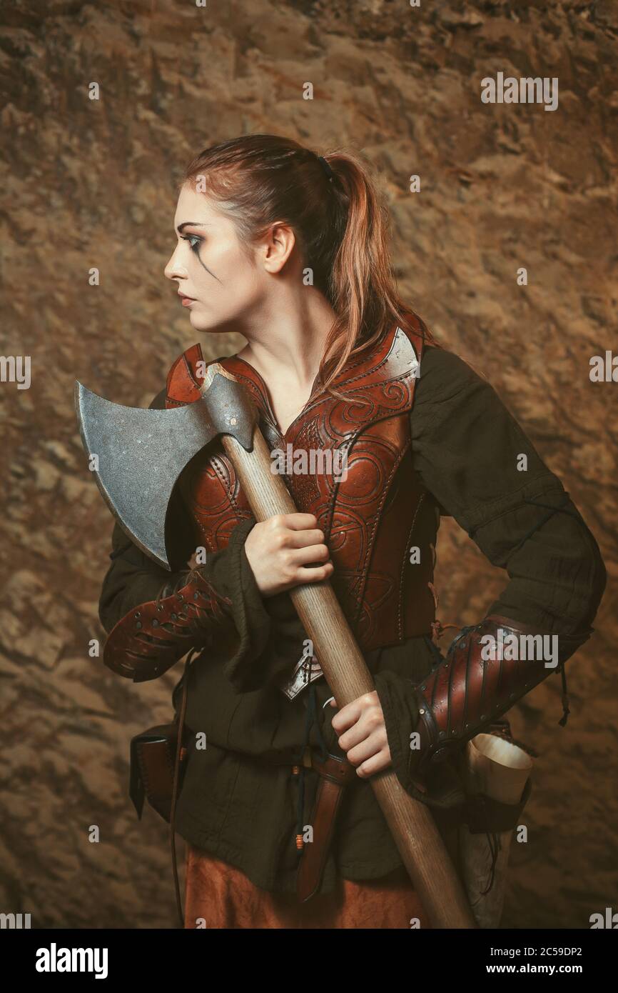 Warrior woman posing with axe and eyes open Stock Photo - Alamy