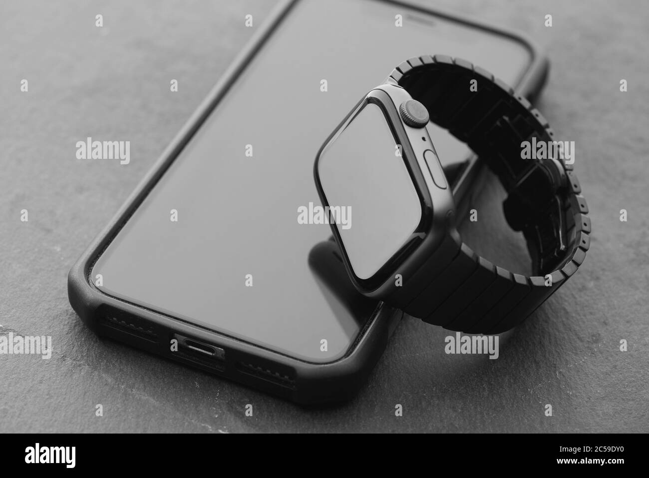 smart watch and smartphone on a stone background Stock Photo - Alamy