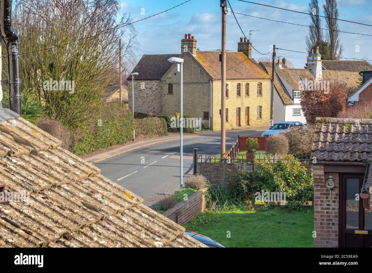 Shallow focus of part of a cottage roof and guttering in the foreground ...