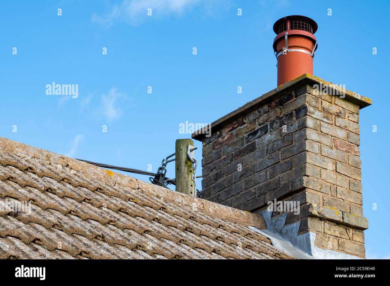 Large, english cottage style brick chimney showing a newly installed ...