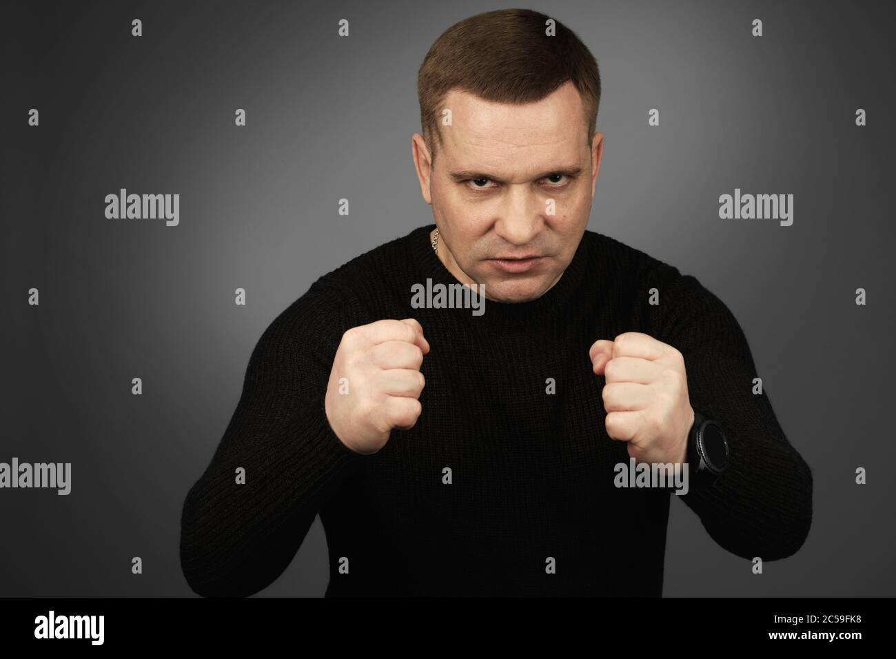 Furious man looking at camera and ready to fight. Studio shot Stock ...