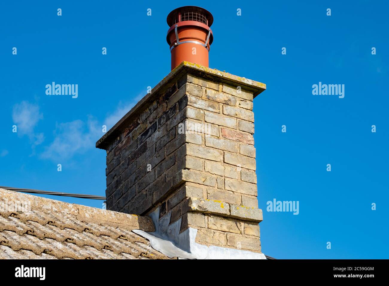 Large, english cottage style brick chimney showing a newly installed ...