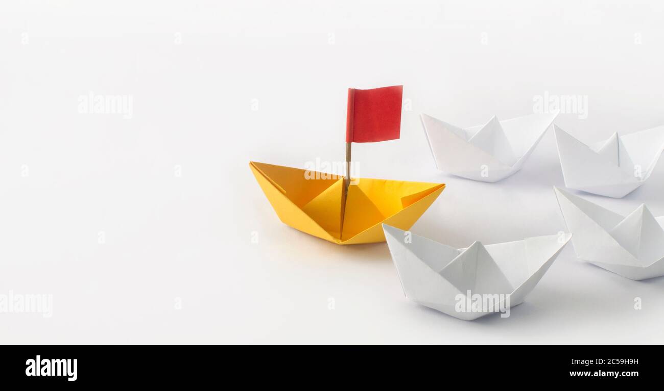 Leadership concept. Red flag Origami Yellow Paper boat (ship) leading ...
