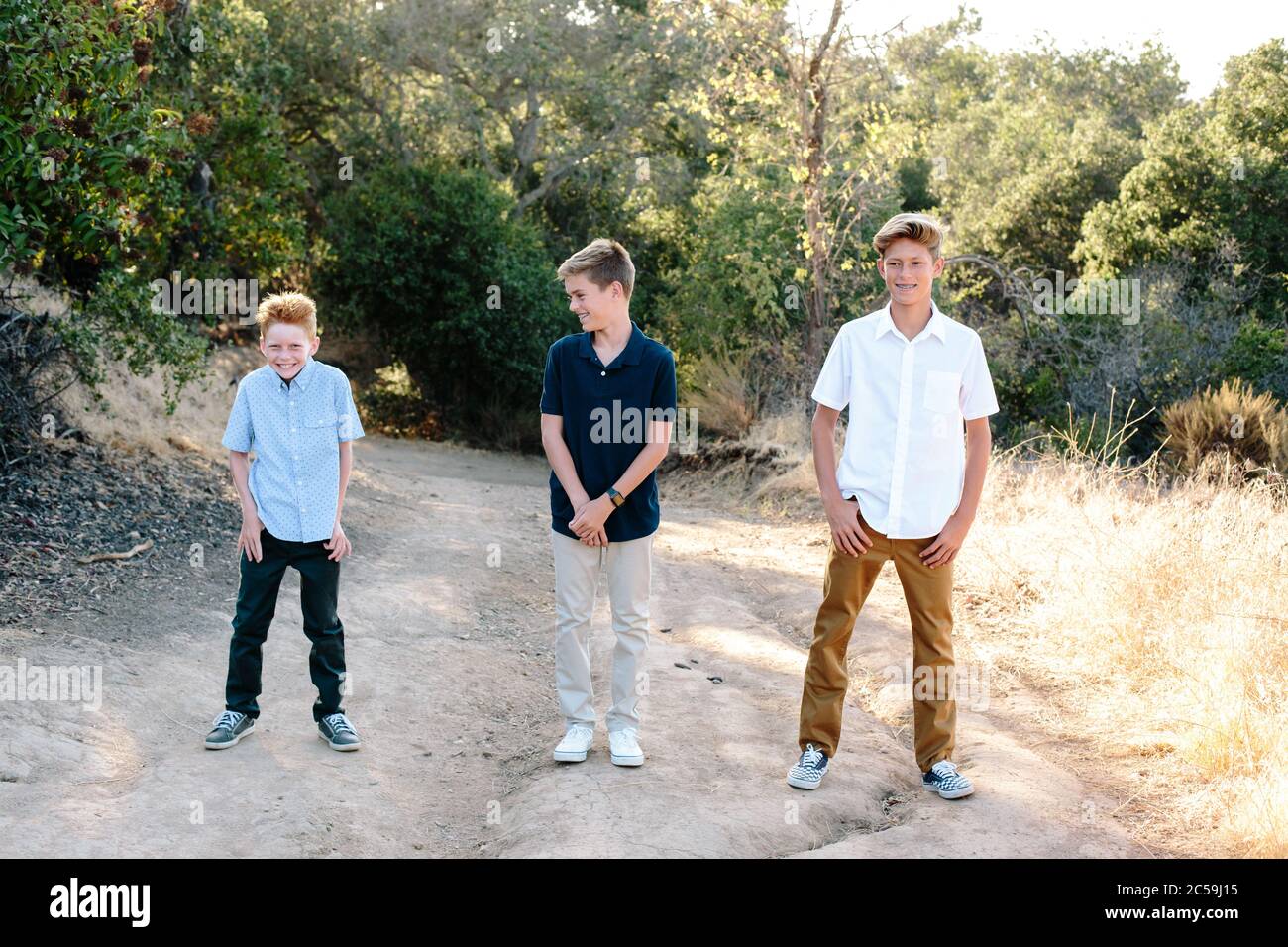 Three Young Brothers Stand Together outside On a Trail Smiling Stock ...