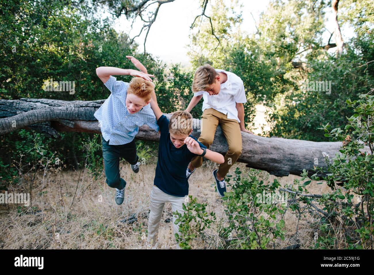 Two boys jumping off red hi-res stock photography and images - Alamy
