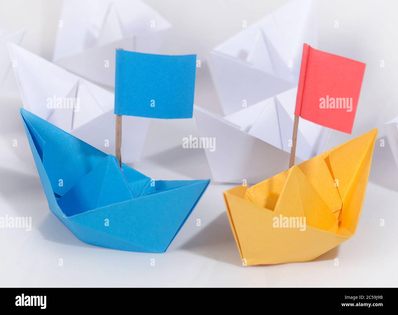 Business competition concept using two different color origami paper ...