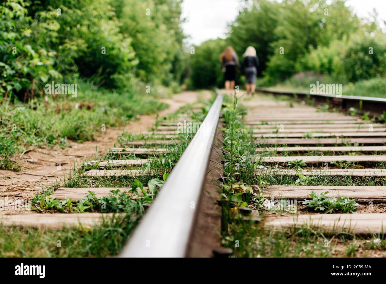 Girls go together by railway Stock Photo - Alamy