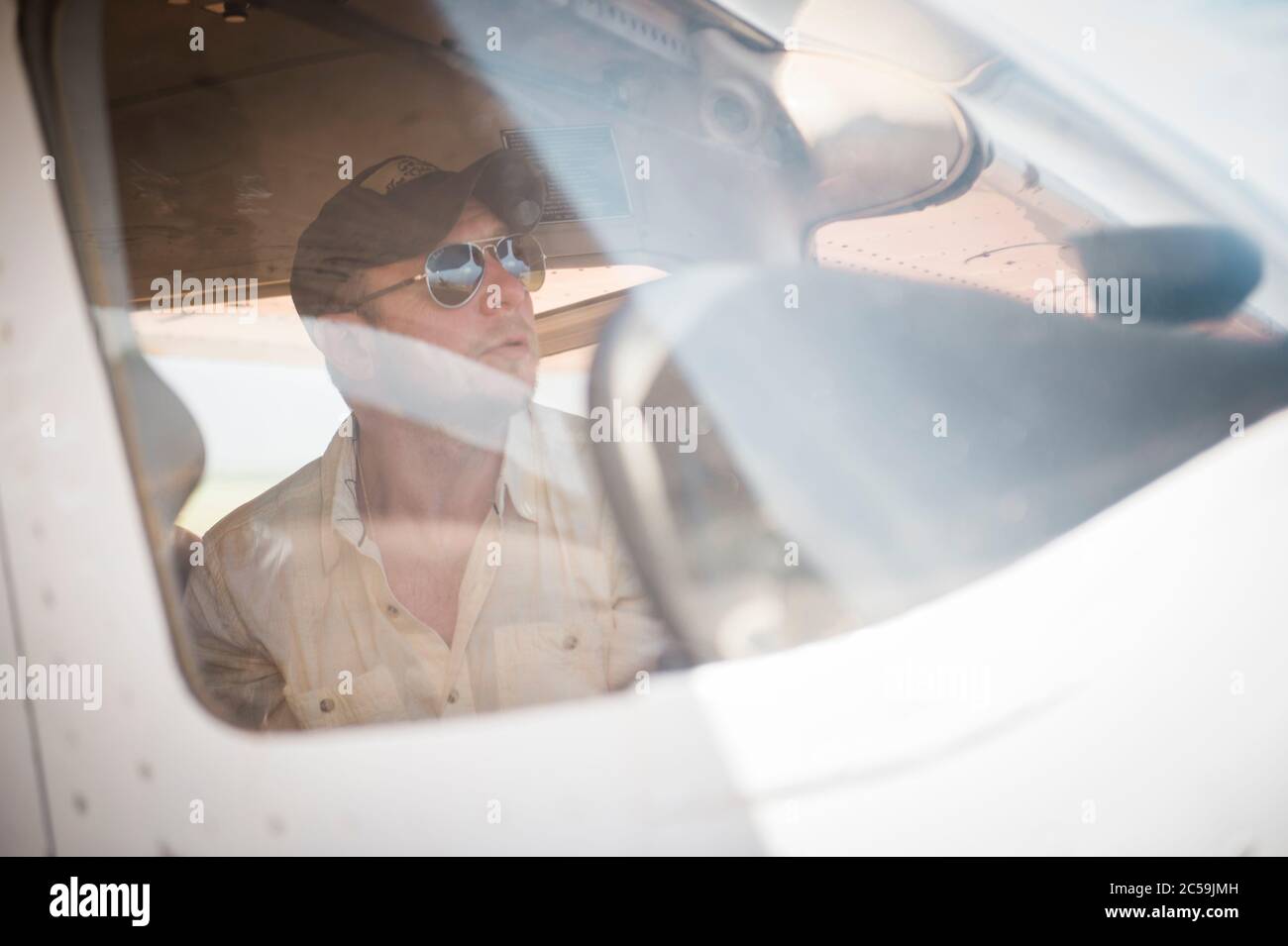 Pilot looking out cockpit window Stock Photo - Alamy