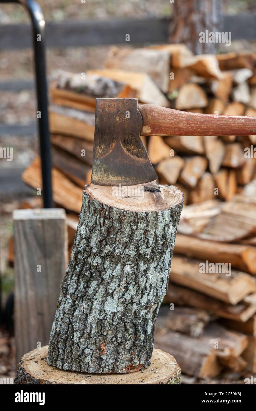 Ax splitting log for firewood Stock Photo - Alamy