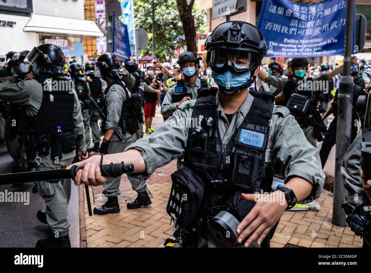 Riot police officer with a baton during the demonstration.Following the ...